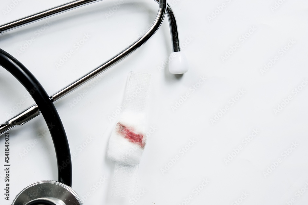 Blood on cotton wool and white plaster on white background with ...