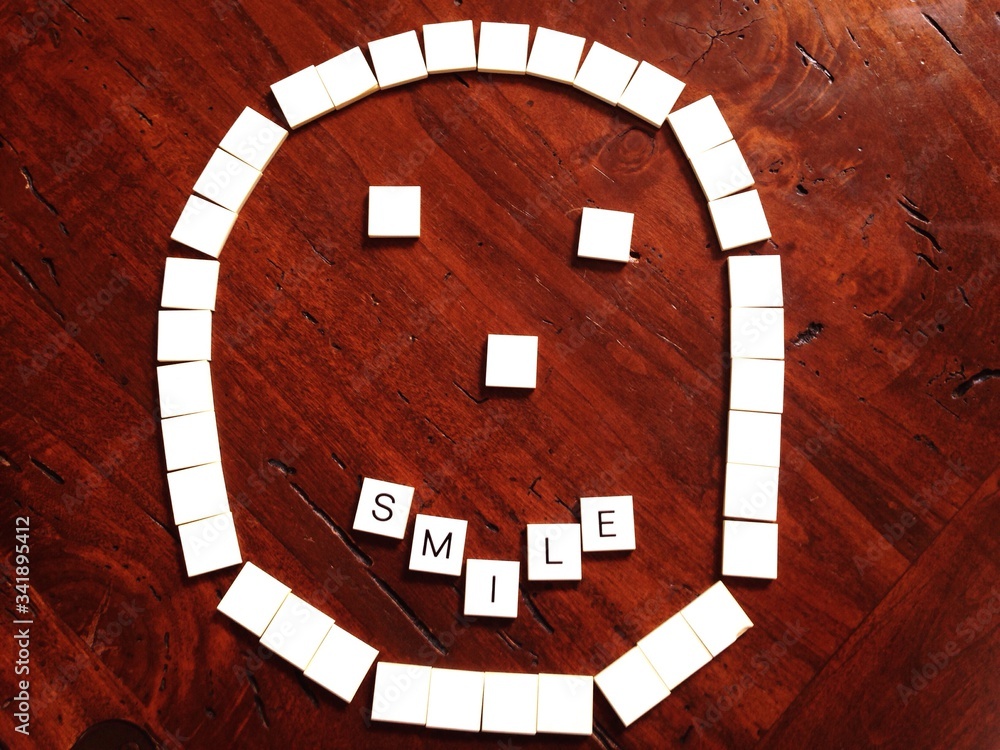 Smiley Face Made Of White Letter Blocks On Table Stock Photo | Adobe Stock