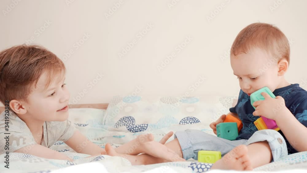 Two happy kids playing and learning. Small brothers having fun together ...