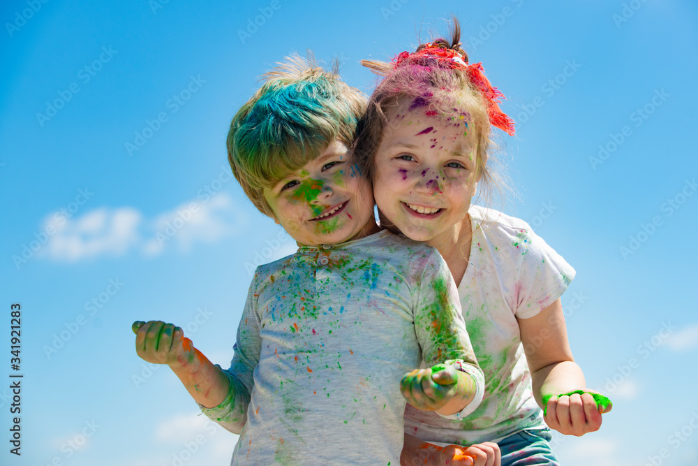 Portrait of bright kids smeared in colored powder holi. Bright and ...