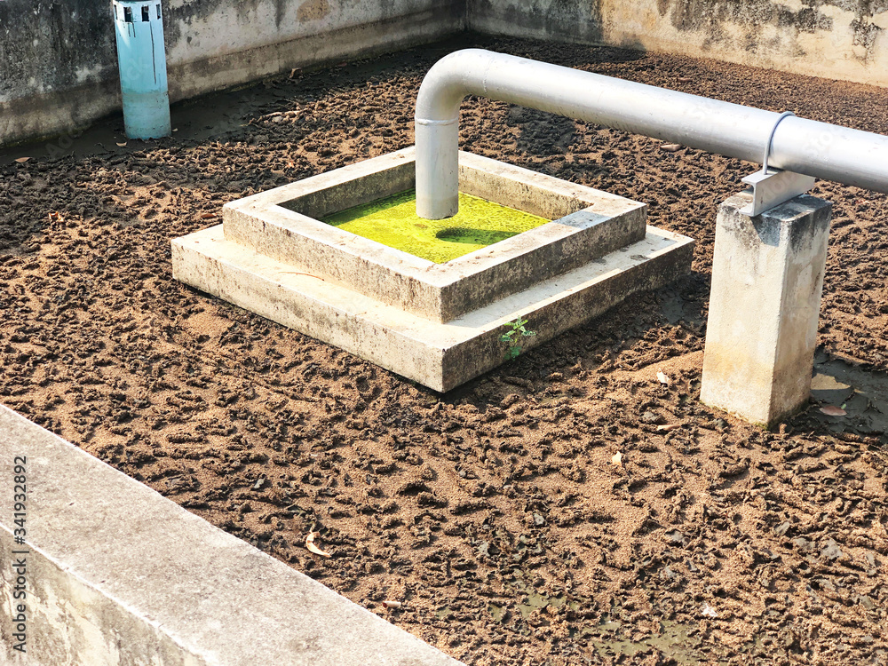 Sludge treatment in wastewater management system, flowing brown smelly ...