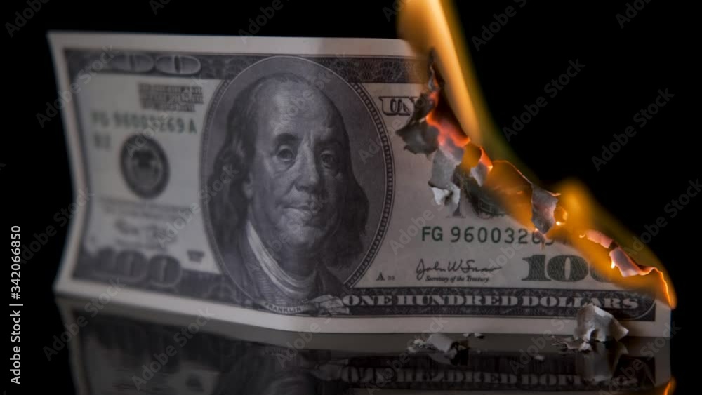 Us dollar bill money is on fire on black background, large frame ...
