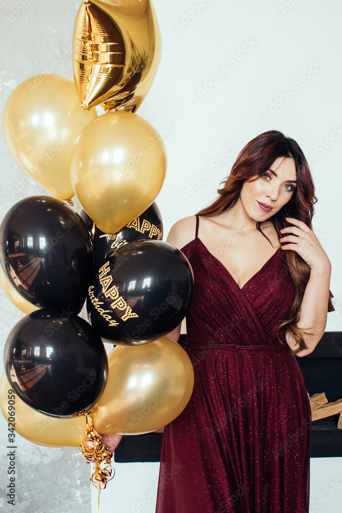 Happy birthday. A girl in a beautiful dress with black and gold ...