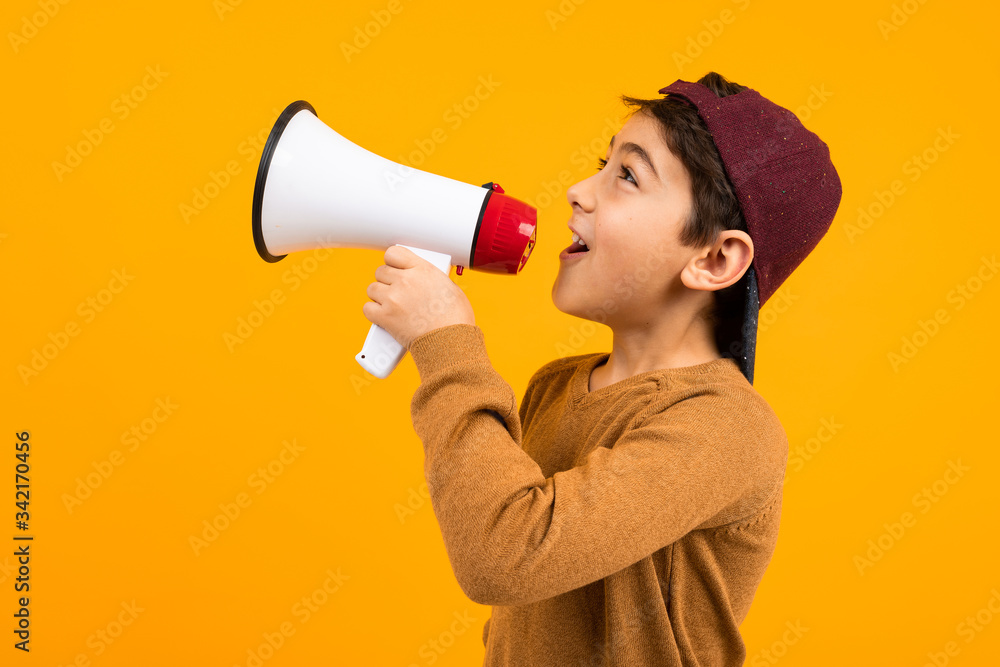 attractive european boy shouting news in a megaphone for a poster on an ...