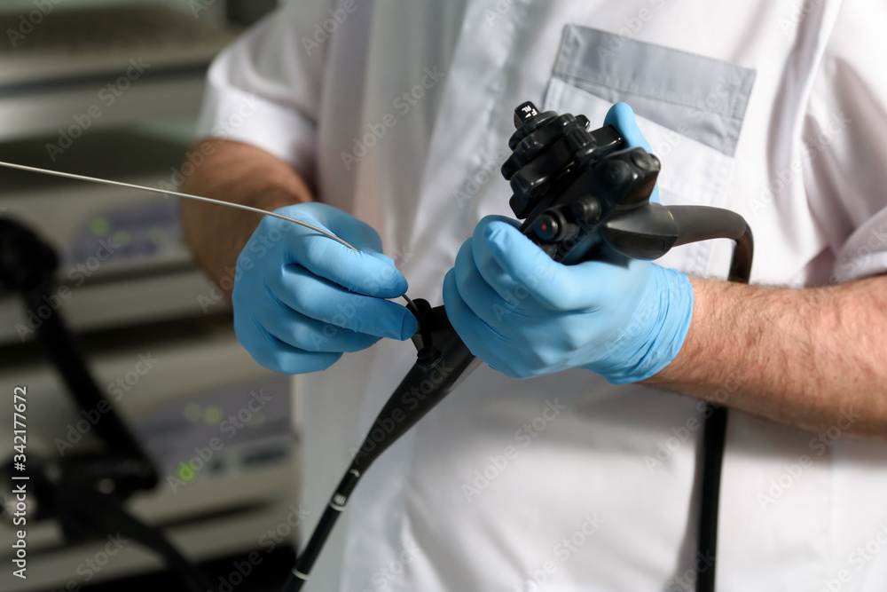 Endoscopic examination in a modern clinic. The doctor holds in his hand ...