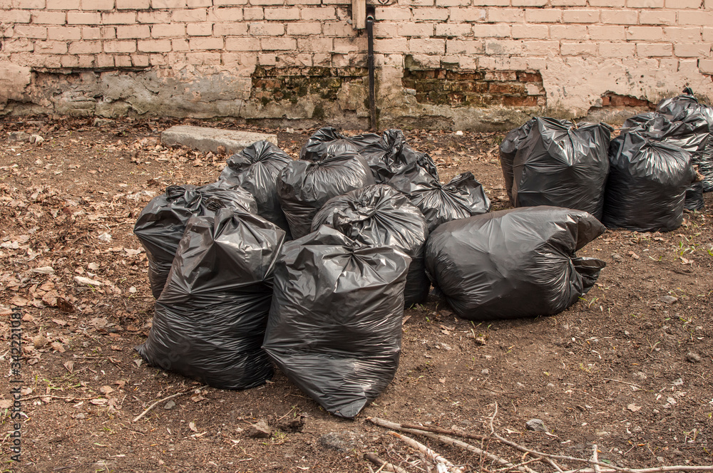 heap garbage plastic bags many in the garden, pollution from trash bag ...