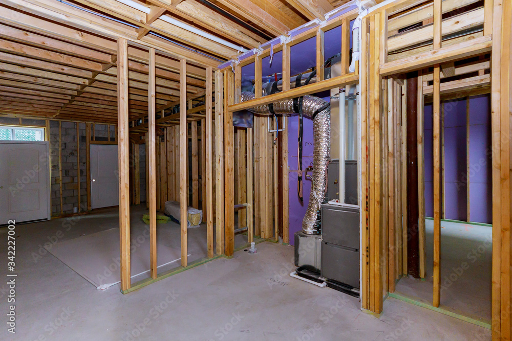 Interior view of a basement under construction home framing beam in ...