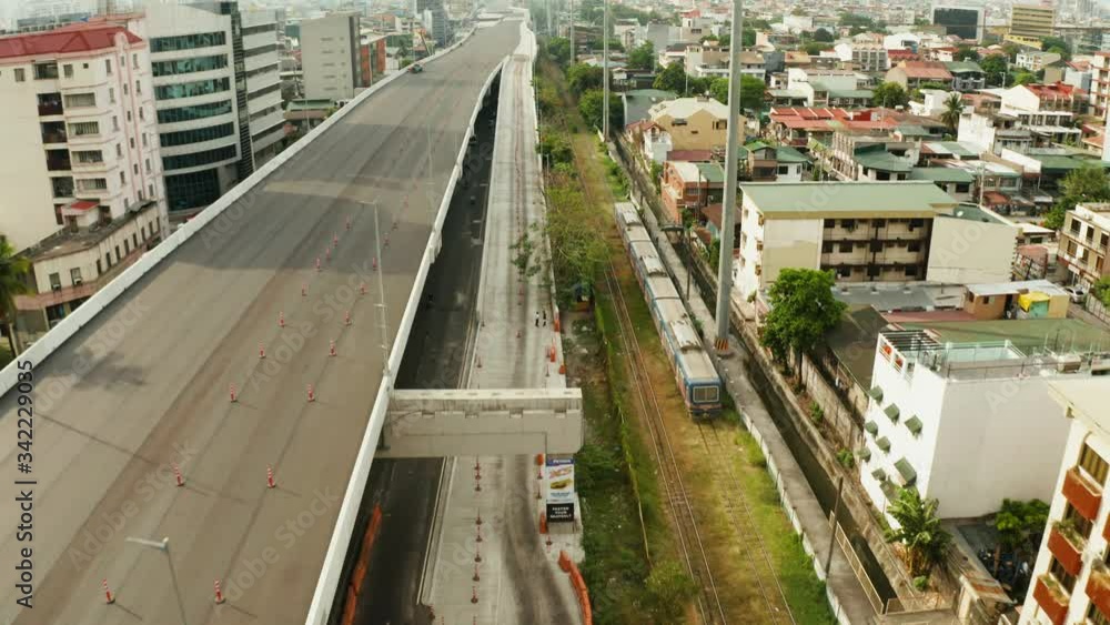 Highway and train on a railway in the city of Manila, Philippines, top ...