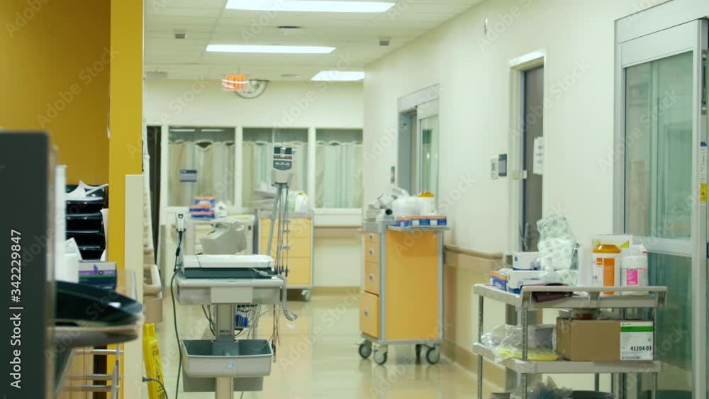 Panning shot down an empty hospital hallway with some scattered ...