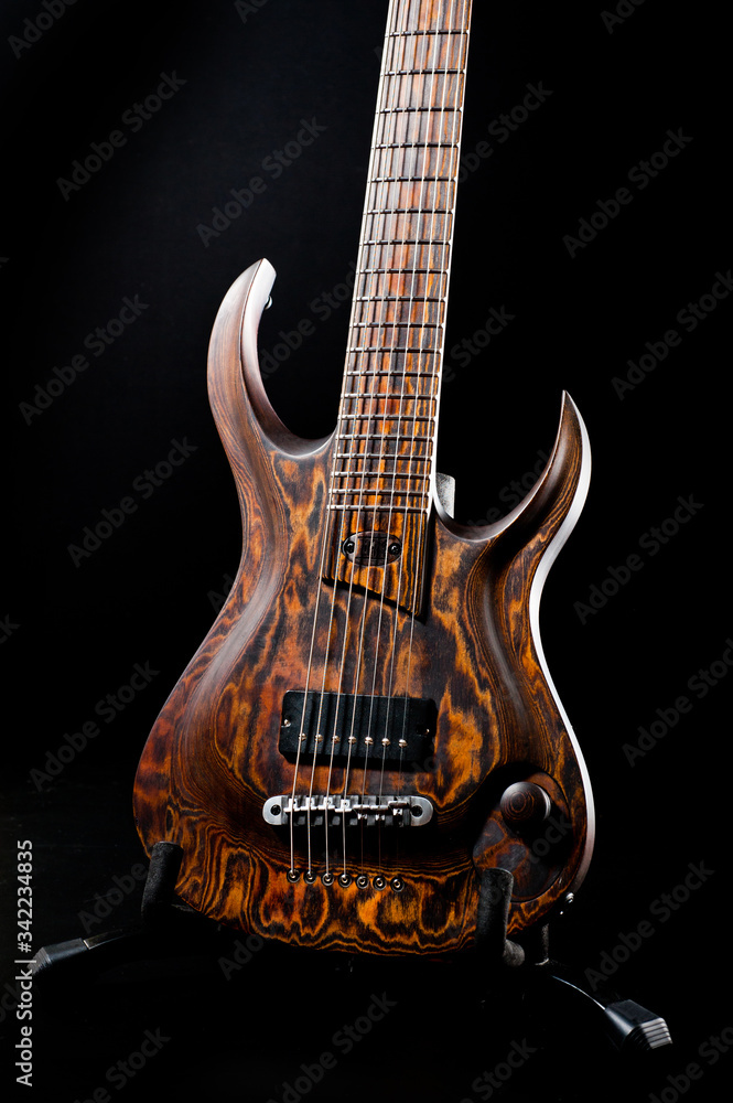 Seven-string electric guitar made of dark wood. Background for music ...