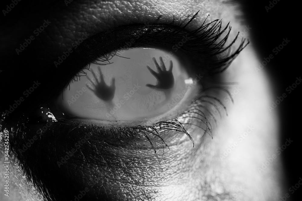 Conceptual monochrome photo of hands holding the bars of prison inside ...