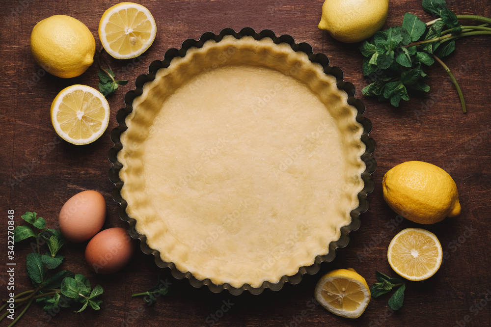 Circular metal flan tin lined with shortcrust pastry. Ingredients for ...