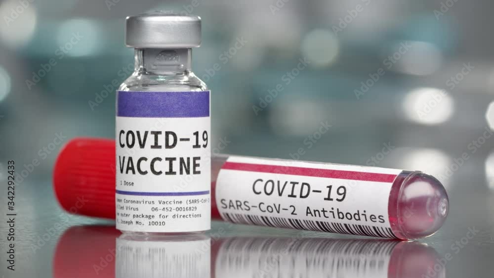 Covid-19 coronavirus vaccine and antibodies vial in medical lab placed ...