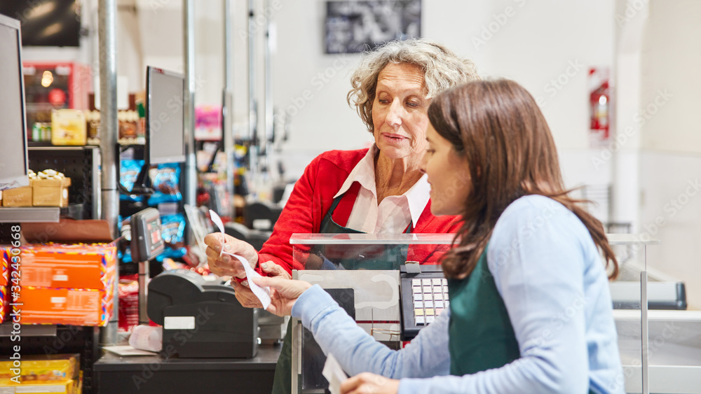 Customer and cashier check a receipt Stock Photo | Adobe Stock