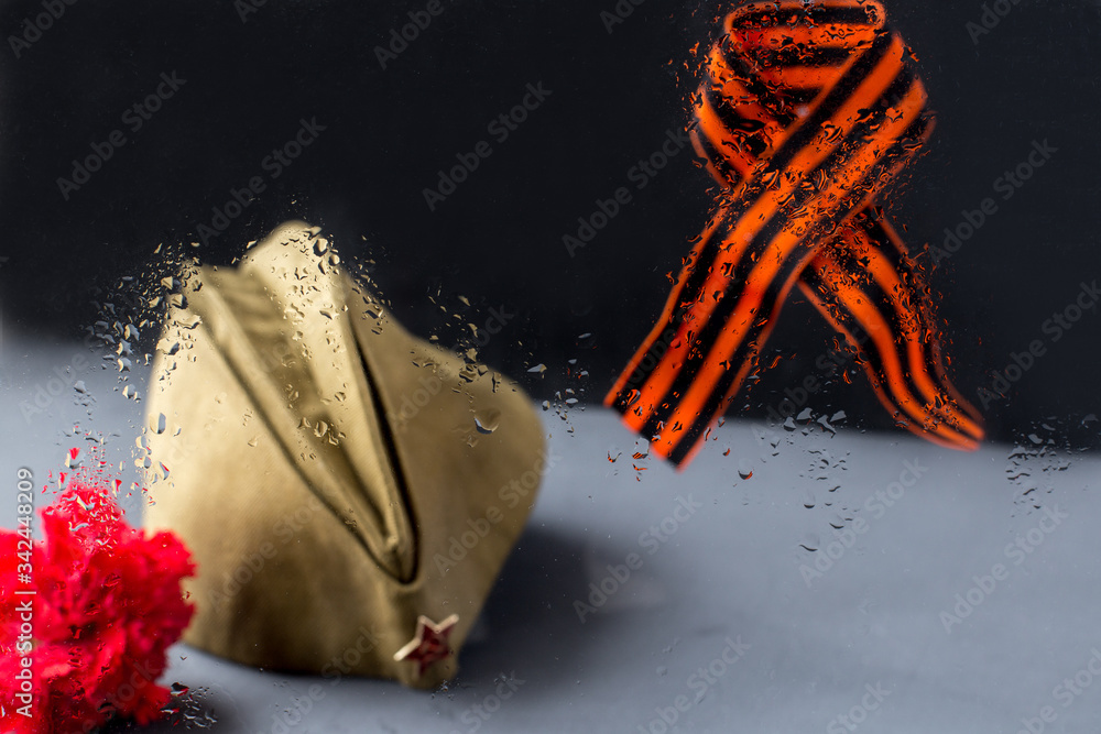 Window,rain drops.Forage,garisson cap of World War II soldier. Red star ...