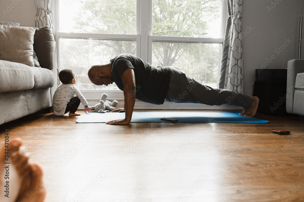 Father and son working out at home with baby during quarantine Stock ...