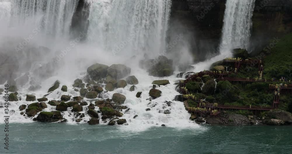 Niagara Falls turbulent river water mist tourist hiking at falls. At ...