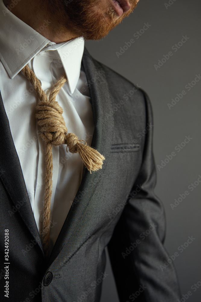 Concept image of business in trouble. Man in suit with Lynch loop ...