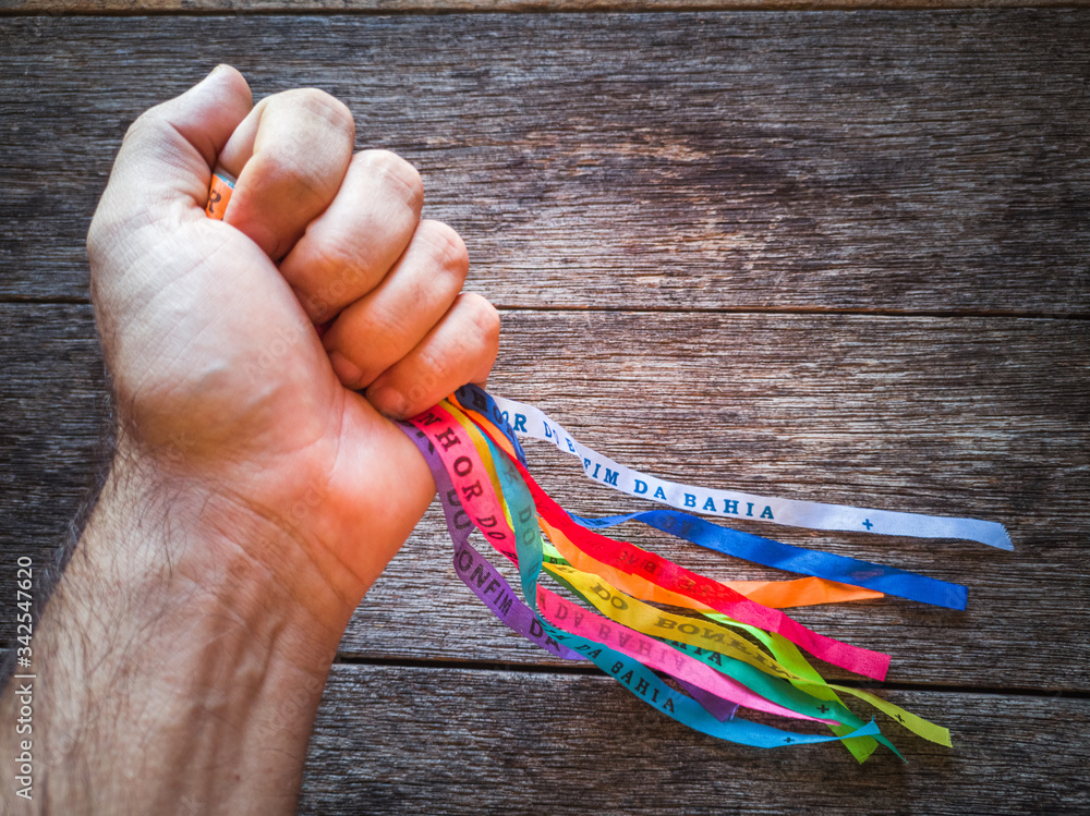 Hands holding Colorful ribbons of Senhor do Bonfim. Symbol of faith of ...