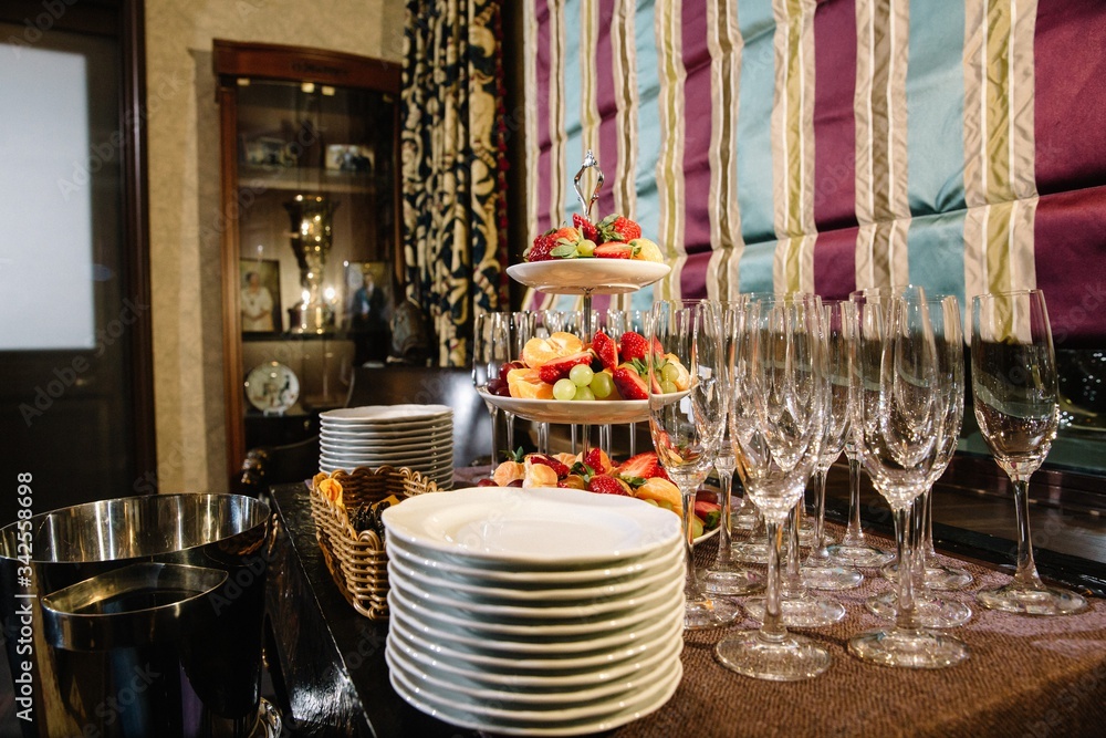A three-tier modern dish with plates and a rod with a ring handle ...