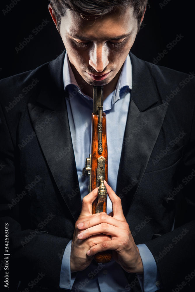 Young Man Holding Musket Standing Against Black Background Stock Photo ...