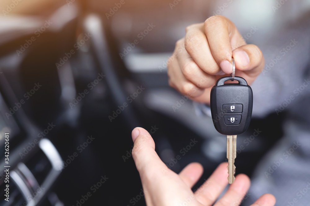 Car key, businessman handing over gives the car key to the other woman ...