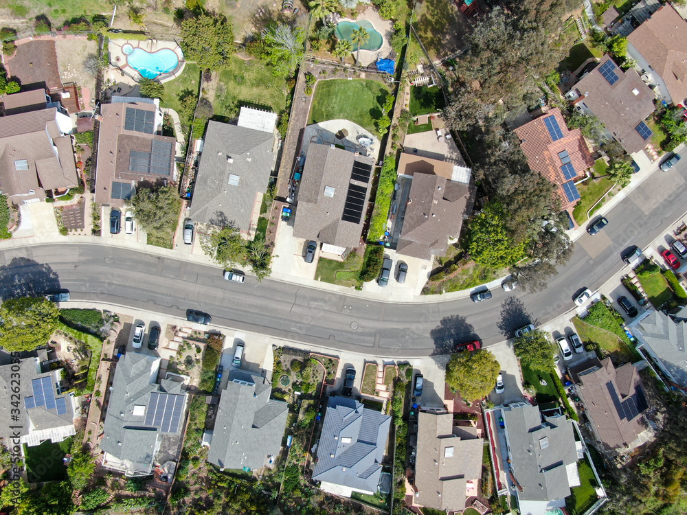 Aerial top view of upper middle class neighborhood street with ...