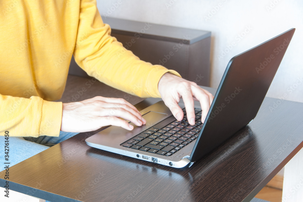 Man hands working laptop computer keyboard at remote workplace. Male ...
