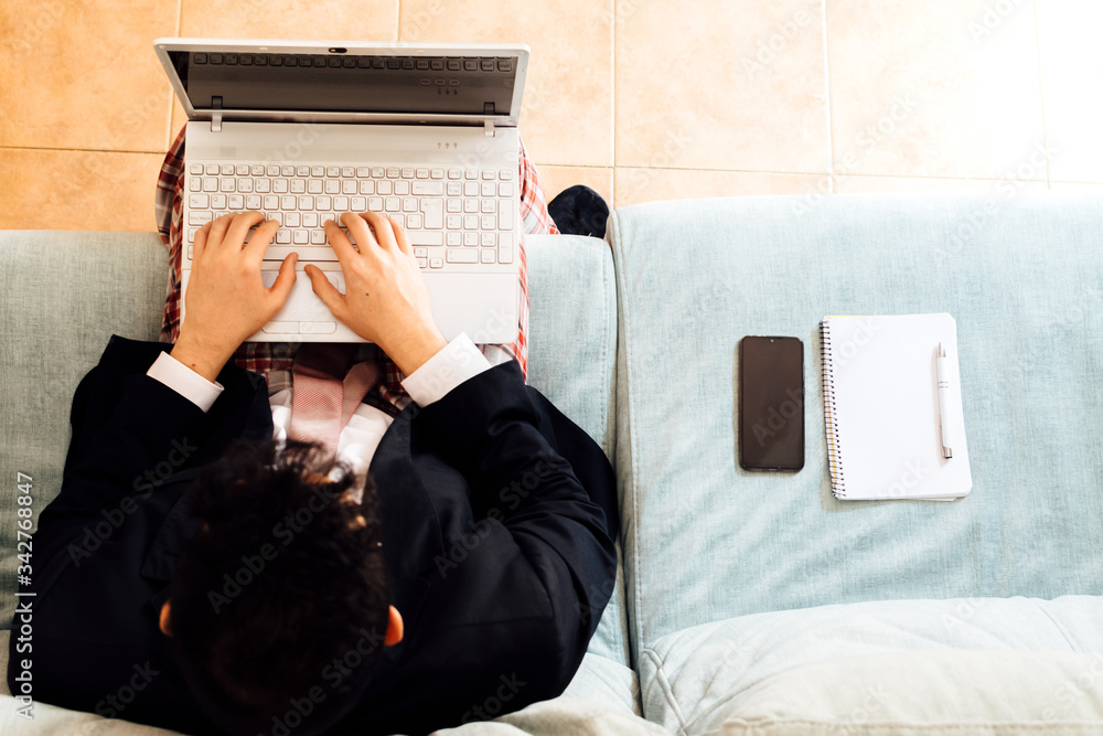 Executive businessman with a mask on his face working from home with ...