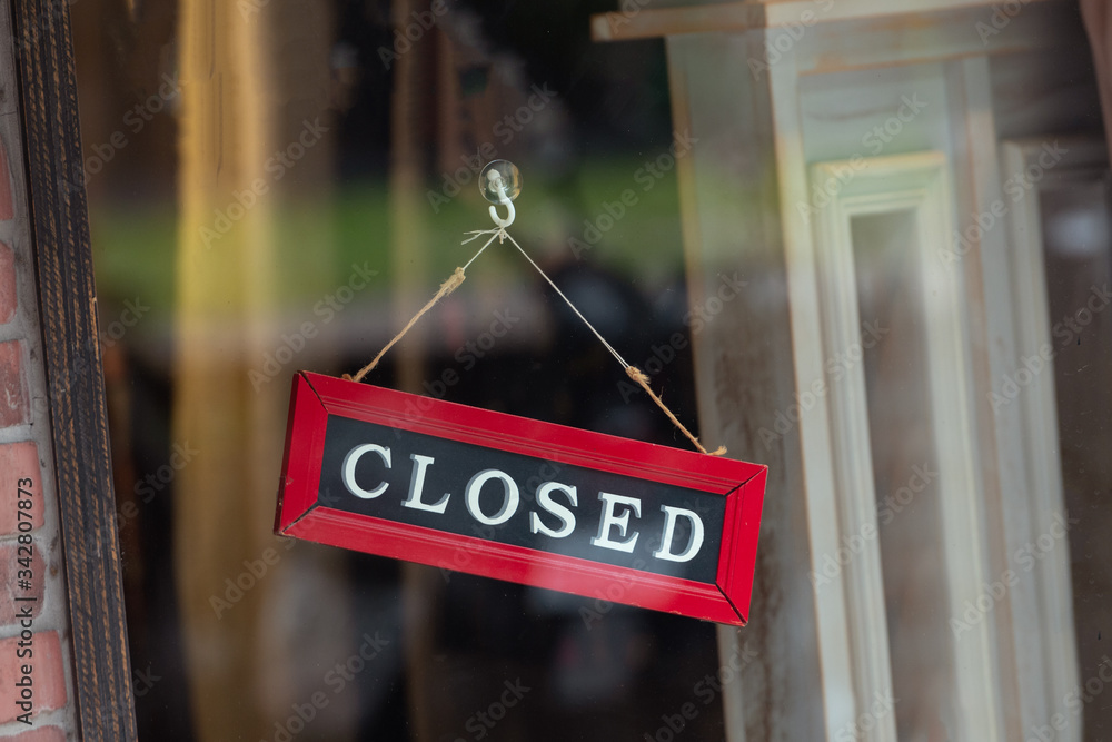 sorry we are closed sign hanging outside a restaurant, store, office or ...
