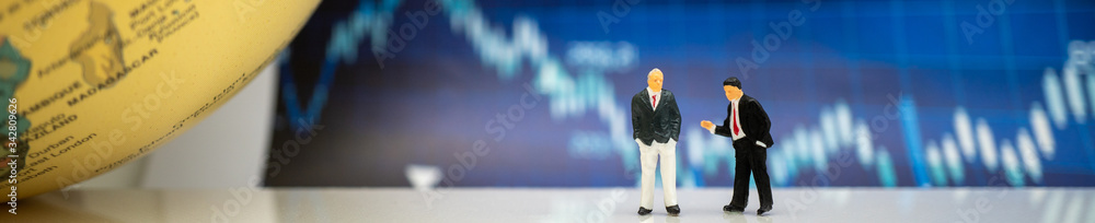Miniature people: Businessmanon with blue graph stock using as ...