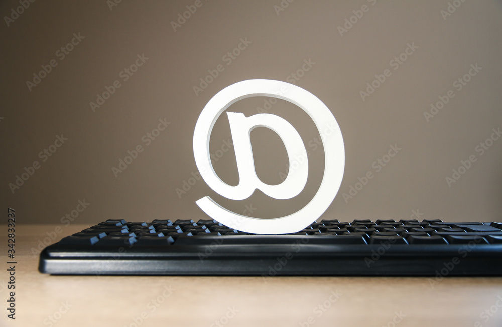 clean at-symbol, at-sign on keyboard with wood surface, symbol for mail ...