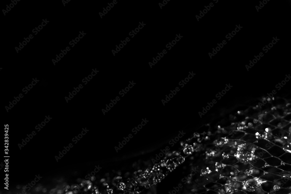 Background and backsplash of wet net with moist crystal water drops ...