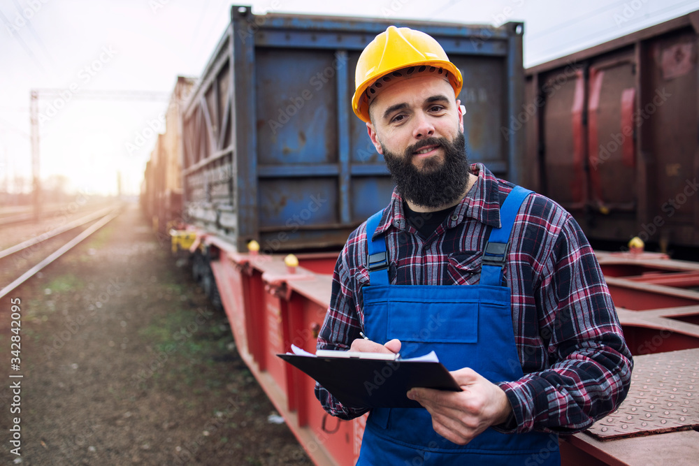 Portrait of shipping worker holding clipboard and dispatching cargo ...