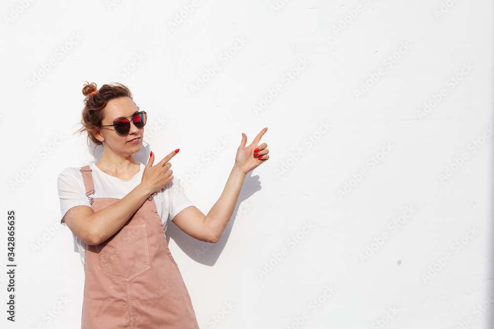 Excited Young Woman In Glasses Pointing Her Index Finger Sideways