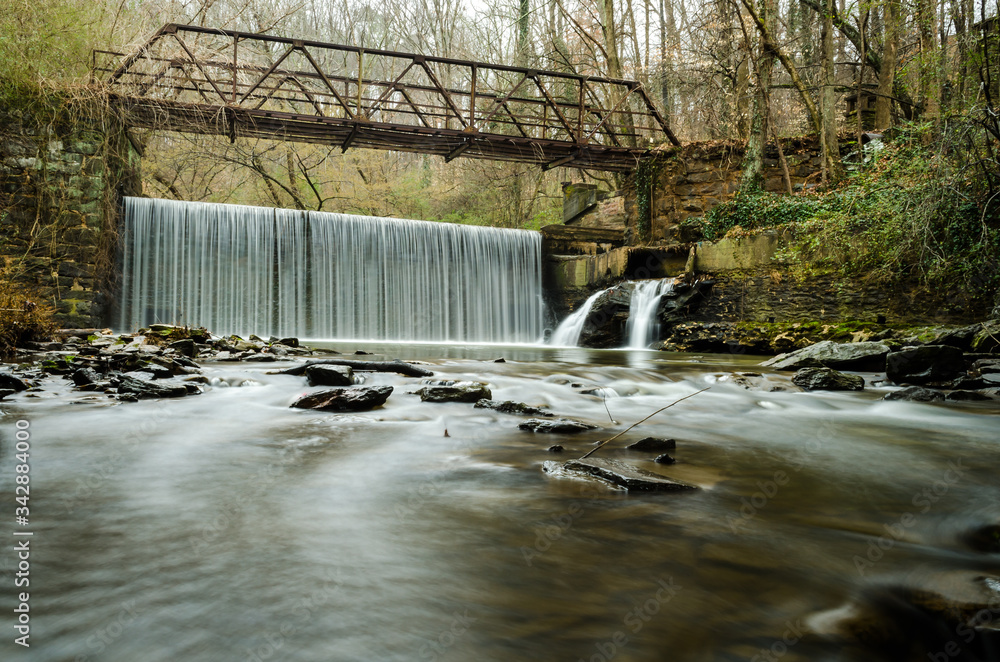 Scenic dam waterfall, bridge, and creek at Hahn Woods at Emory ...