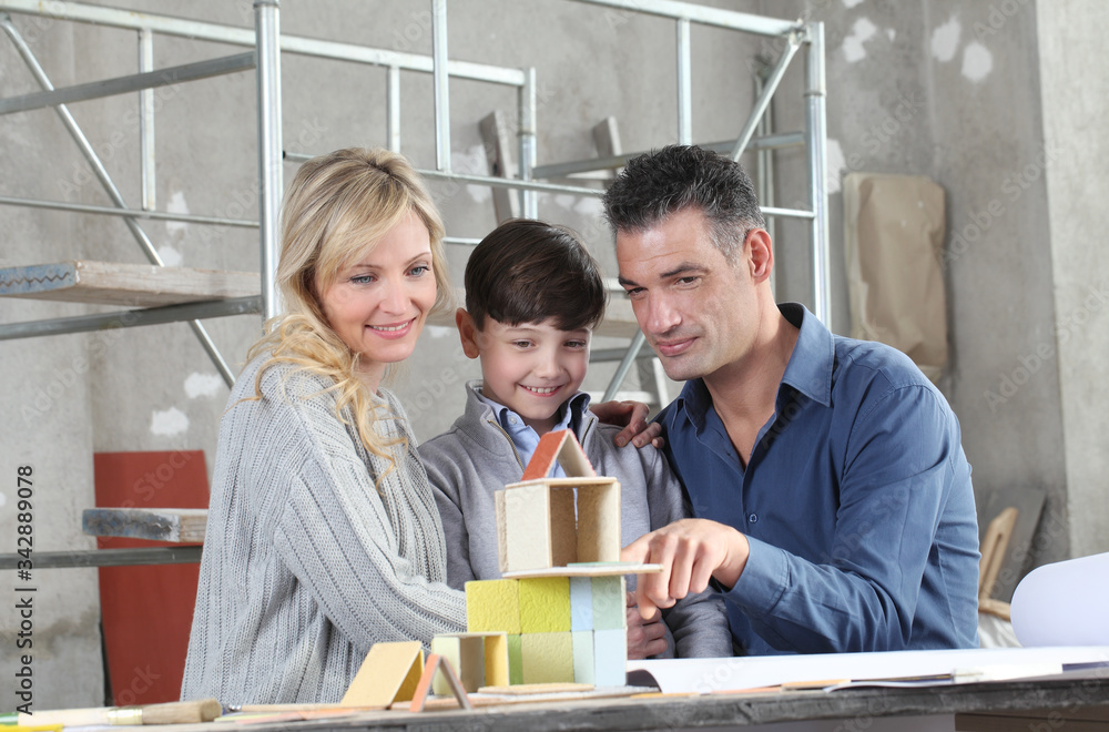 Happy children and his family playing building a house with ...