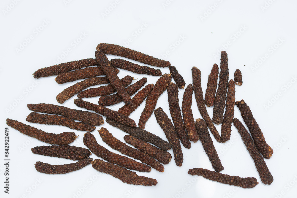 Long pepper or Piper longum on white background Long black pepper (Also ...