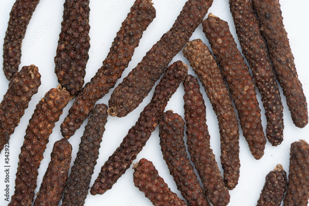 Fotka „Long pepper or Piper longum on white background Long black ...