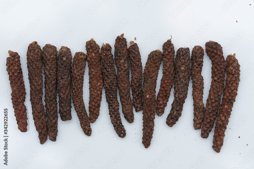 Long pepper or Piper longum on white background Long black pepper (Also ...
