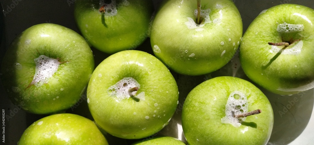Wet soapy green apples. Thoroughly wash vegetables and fruits with ...