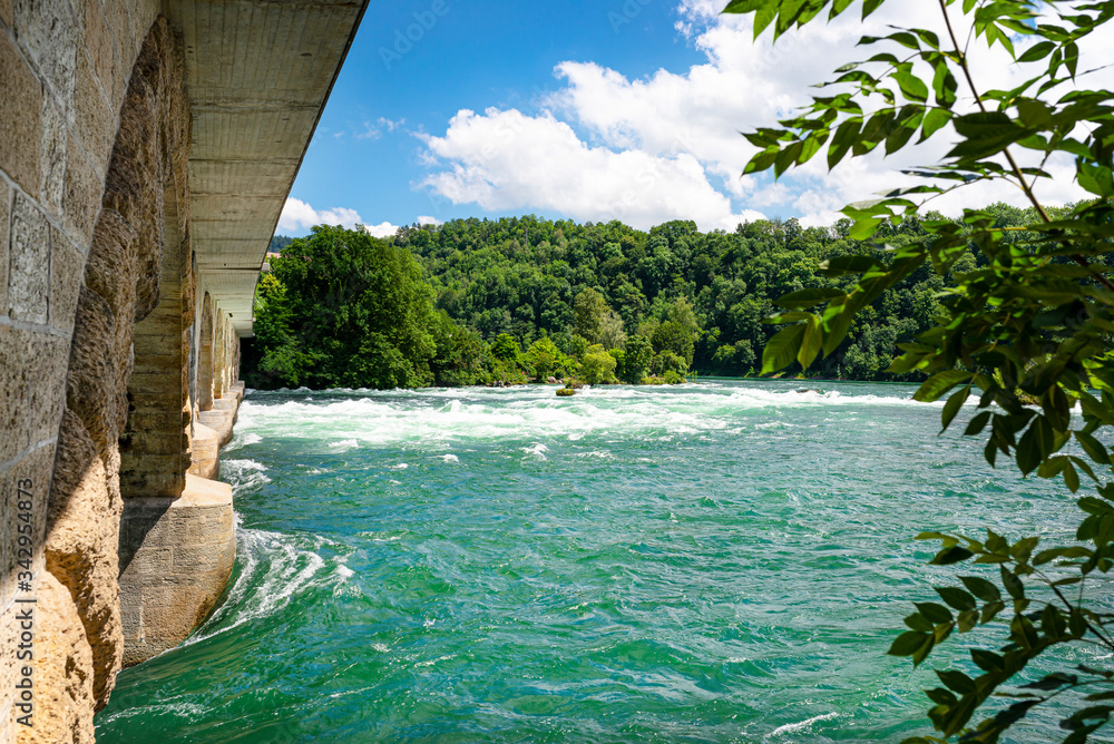 Concrete bridge over the river in a beautiful turquoise color, visible ...