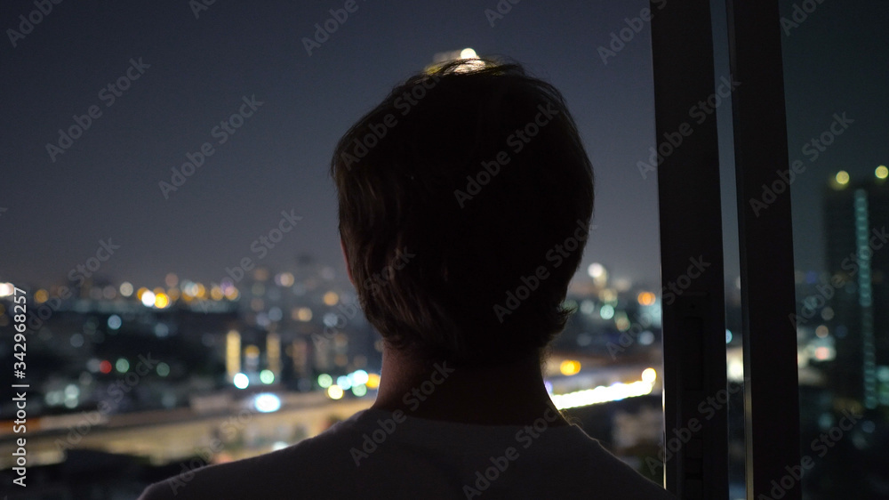 Sucessful Young Man Looking at City Skyline From High Rise Apartment ...