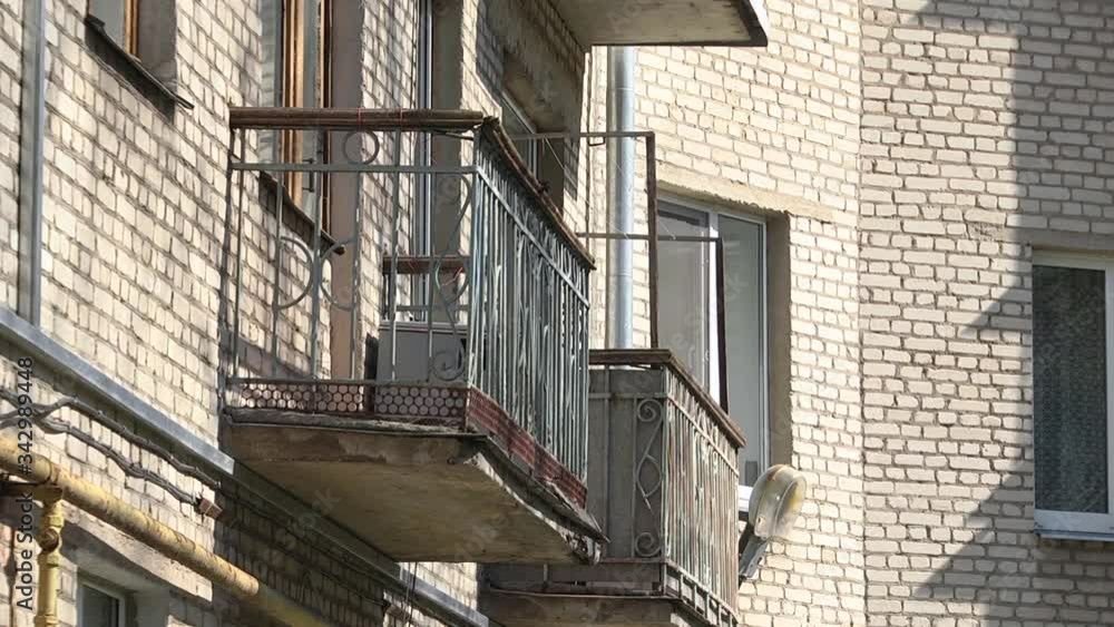 old house with old architectural balcony. The view from the windows of ...