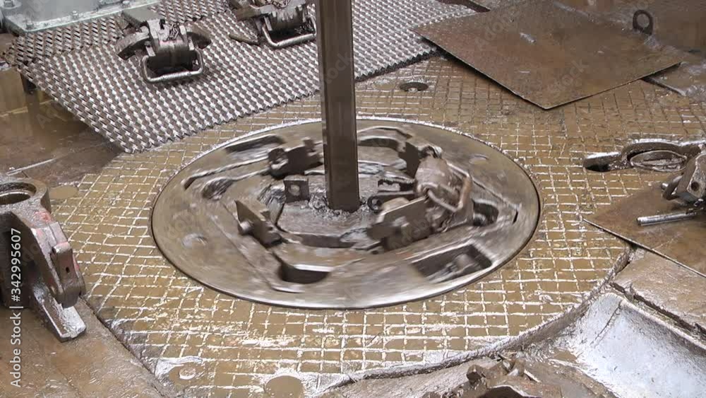 Stickup and rotary table on an offshore oil rig. Drilling string in the ...