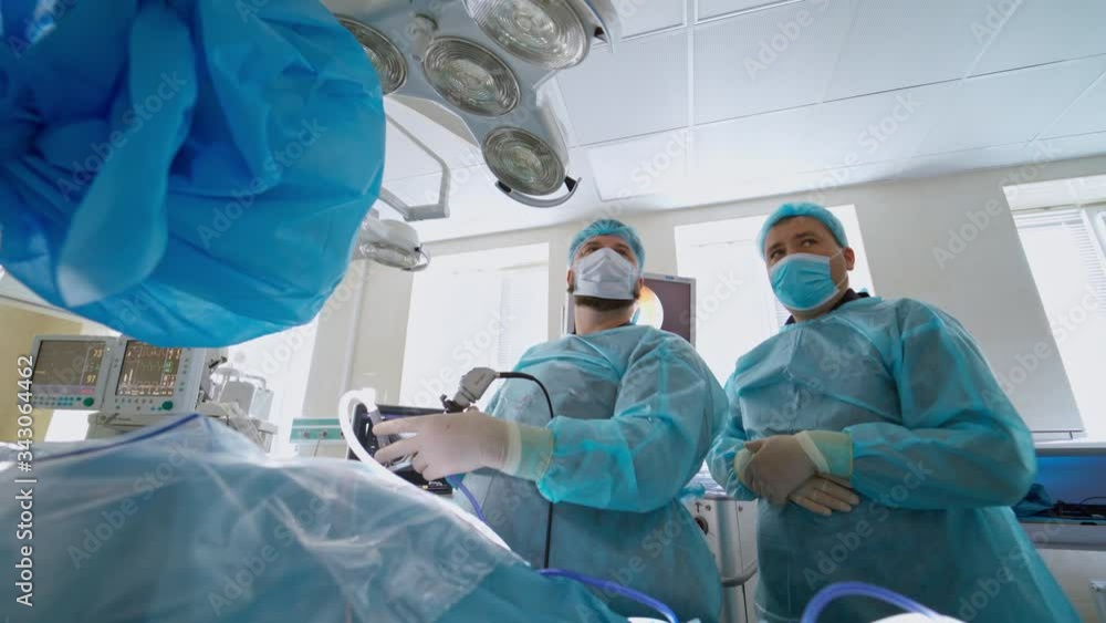 Professional surgeons during the operation to a patient. Doctors in ...