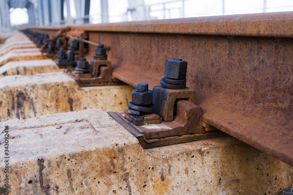 Railway rail, beams, and bolts with reinforcement close up. Railway ...