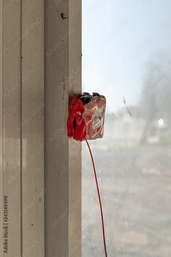 molten fire alarm box in a building after a fire. violation of fire ...