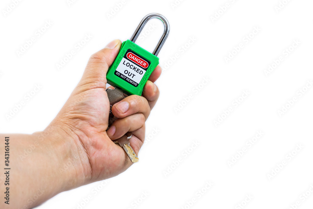 Hand holding green key lock and tag for process cut off electrical,the ...
