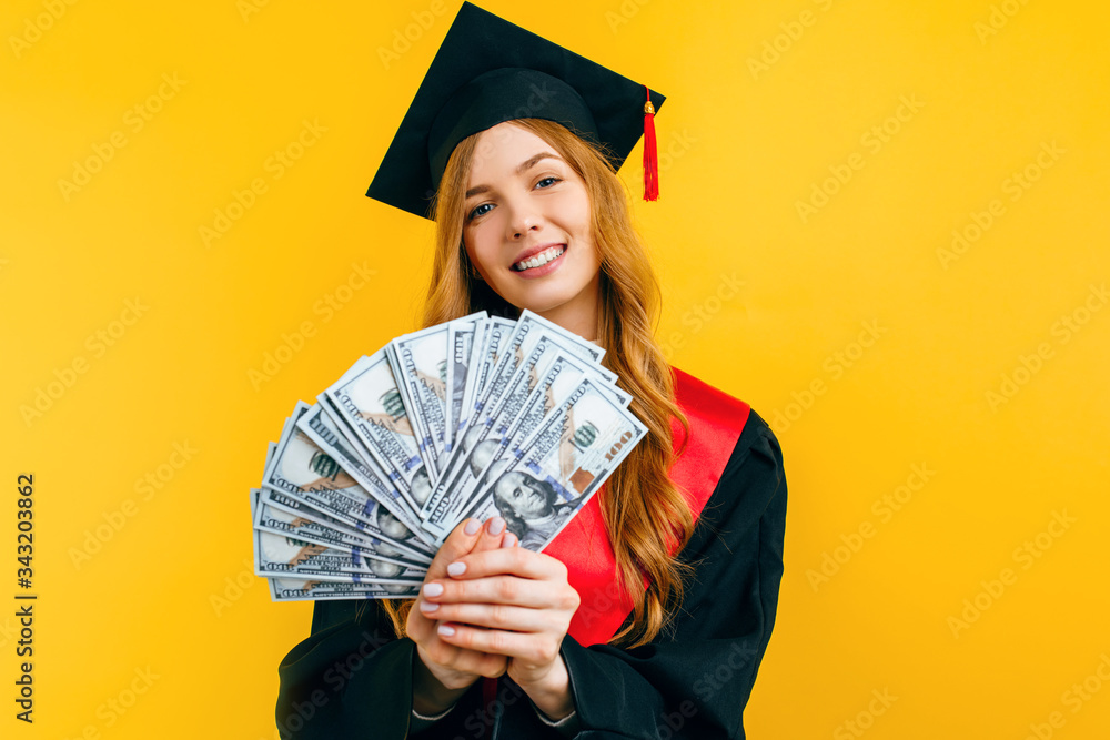 beautiful graduate girl, in a black gown, and a black master's hat ...